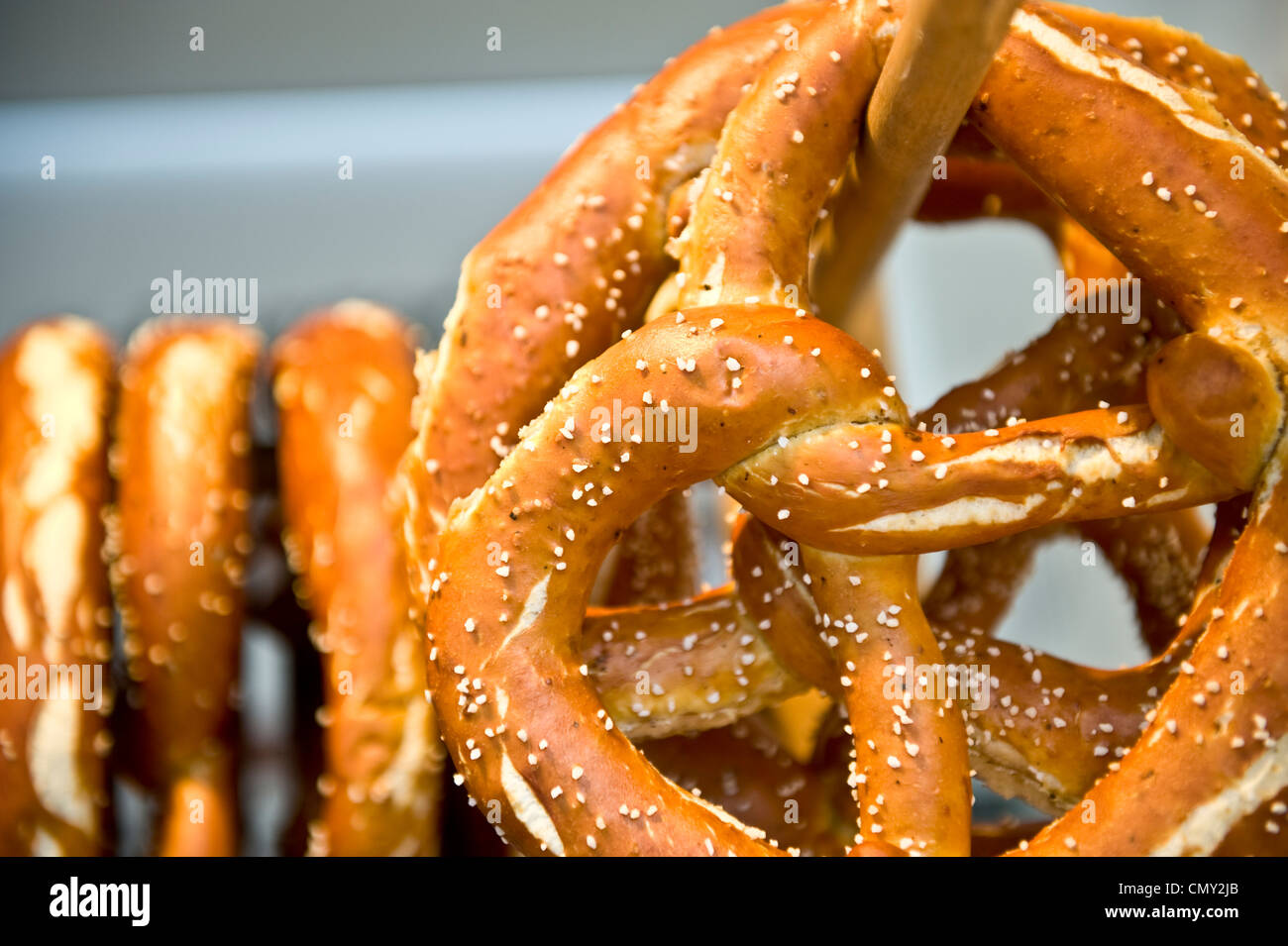 A lineup of fresh pretzels on a wood rack Stock Photo - Alamy