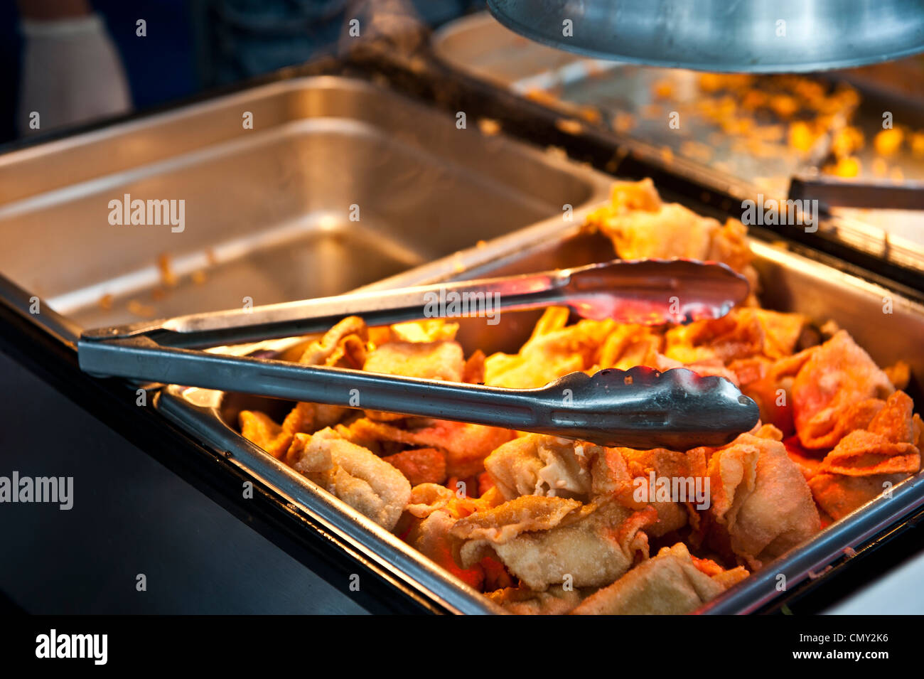 A photograph of fried dumplings in a buffet tray Stock Photo - Alamy