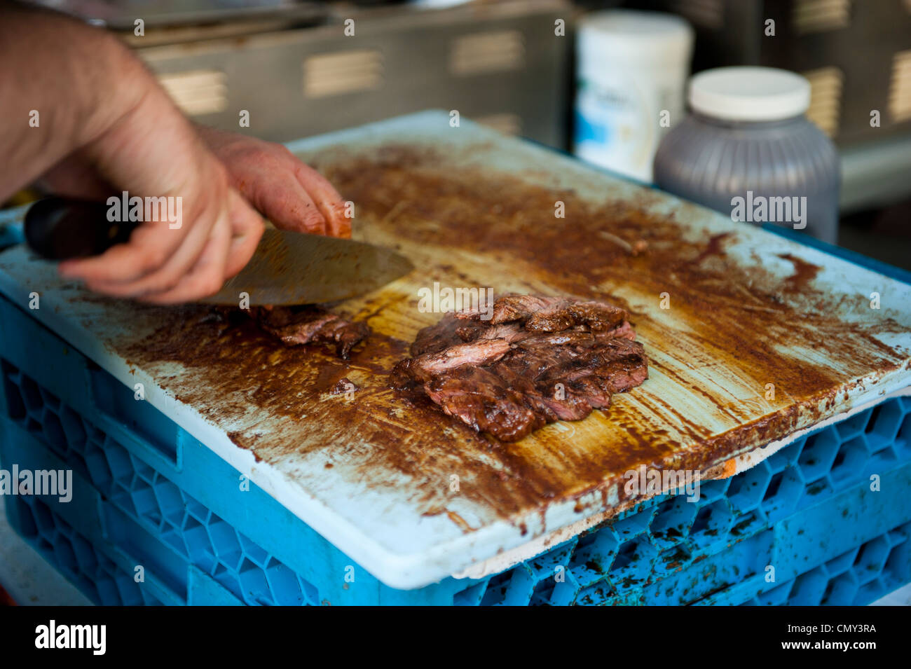 A closeup shot of a cook chopping up steak Stock Photo - Alamy