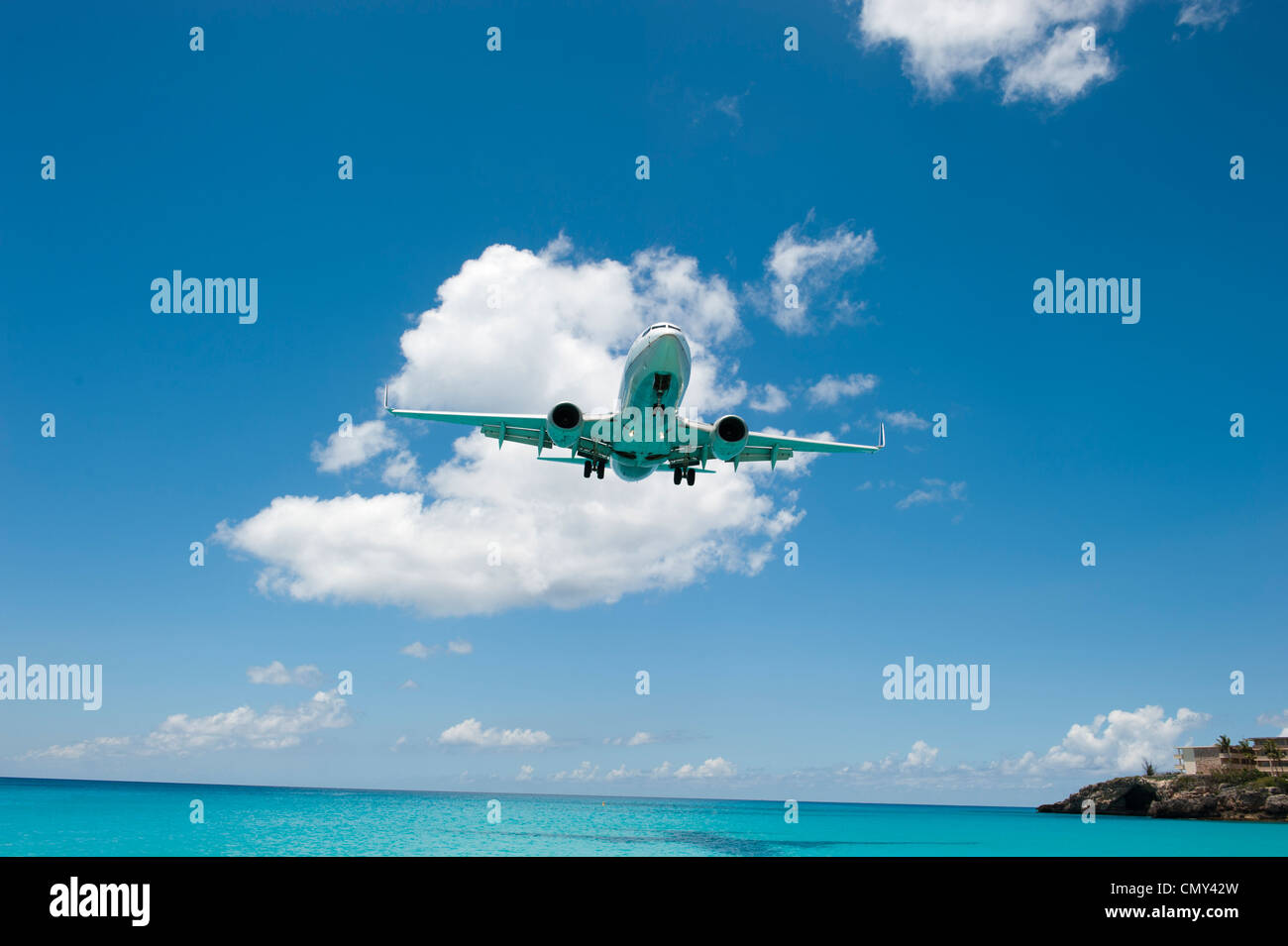 A large airplane landing on a remote island for a vacation Stock Photo ...