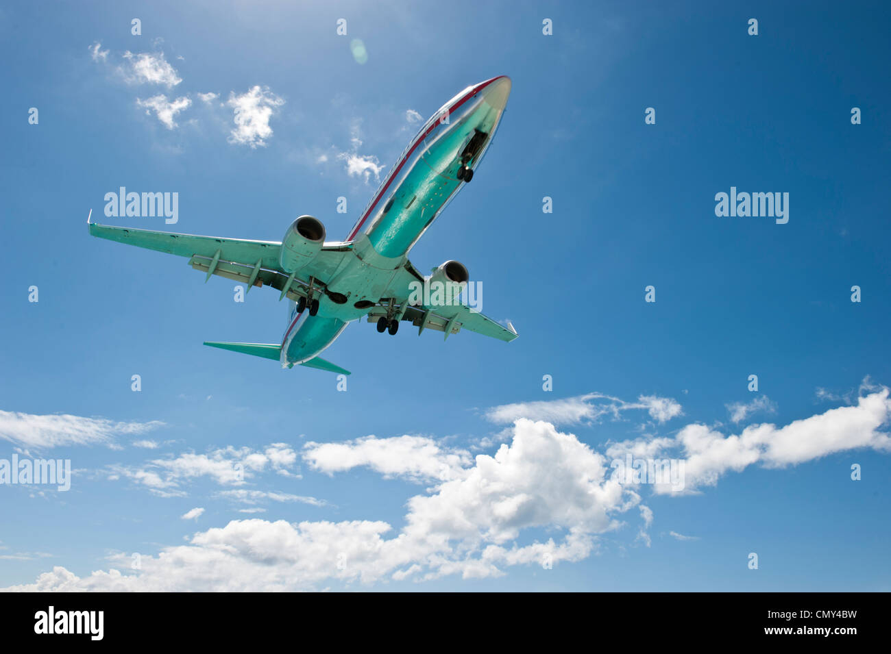 An angular shot of an airplane flying over the ocean, in cloudy weather ...
