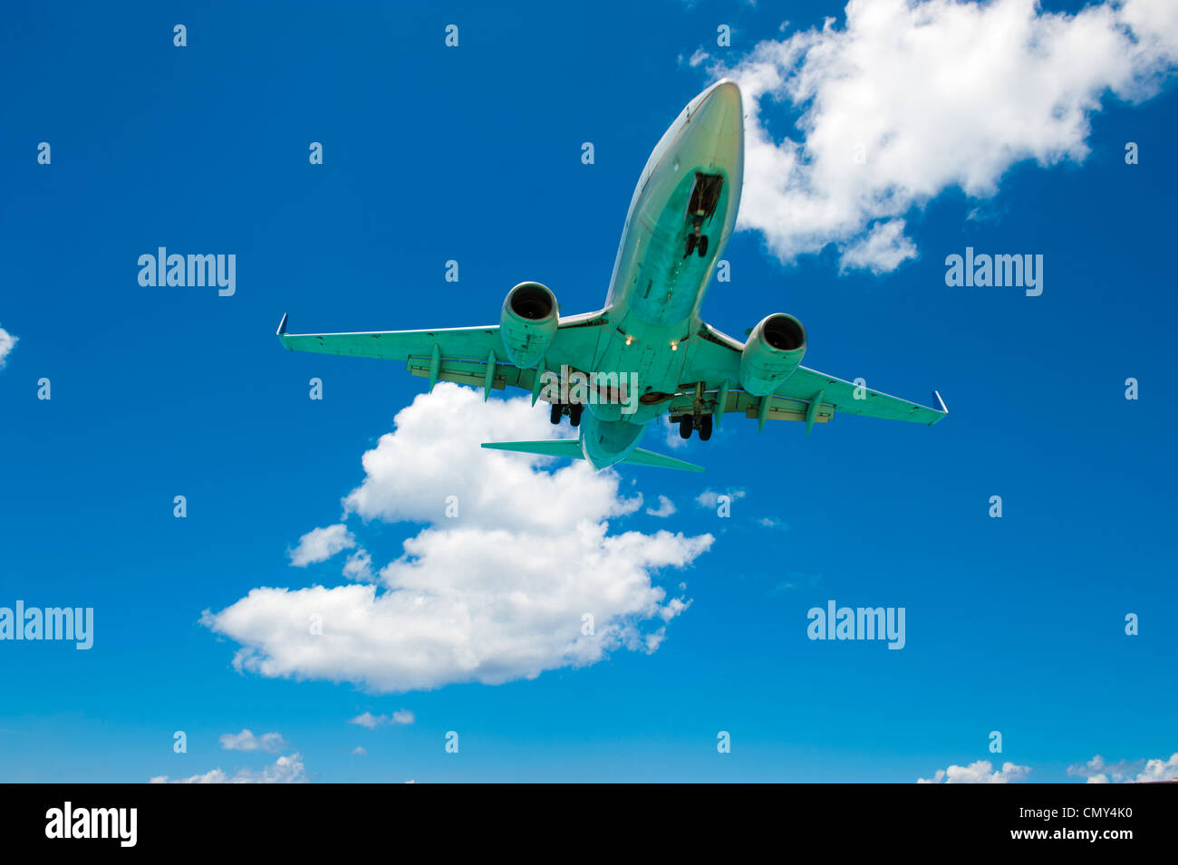 An airplane flying sky high where you can see underneath it Stock Photo ...