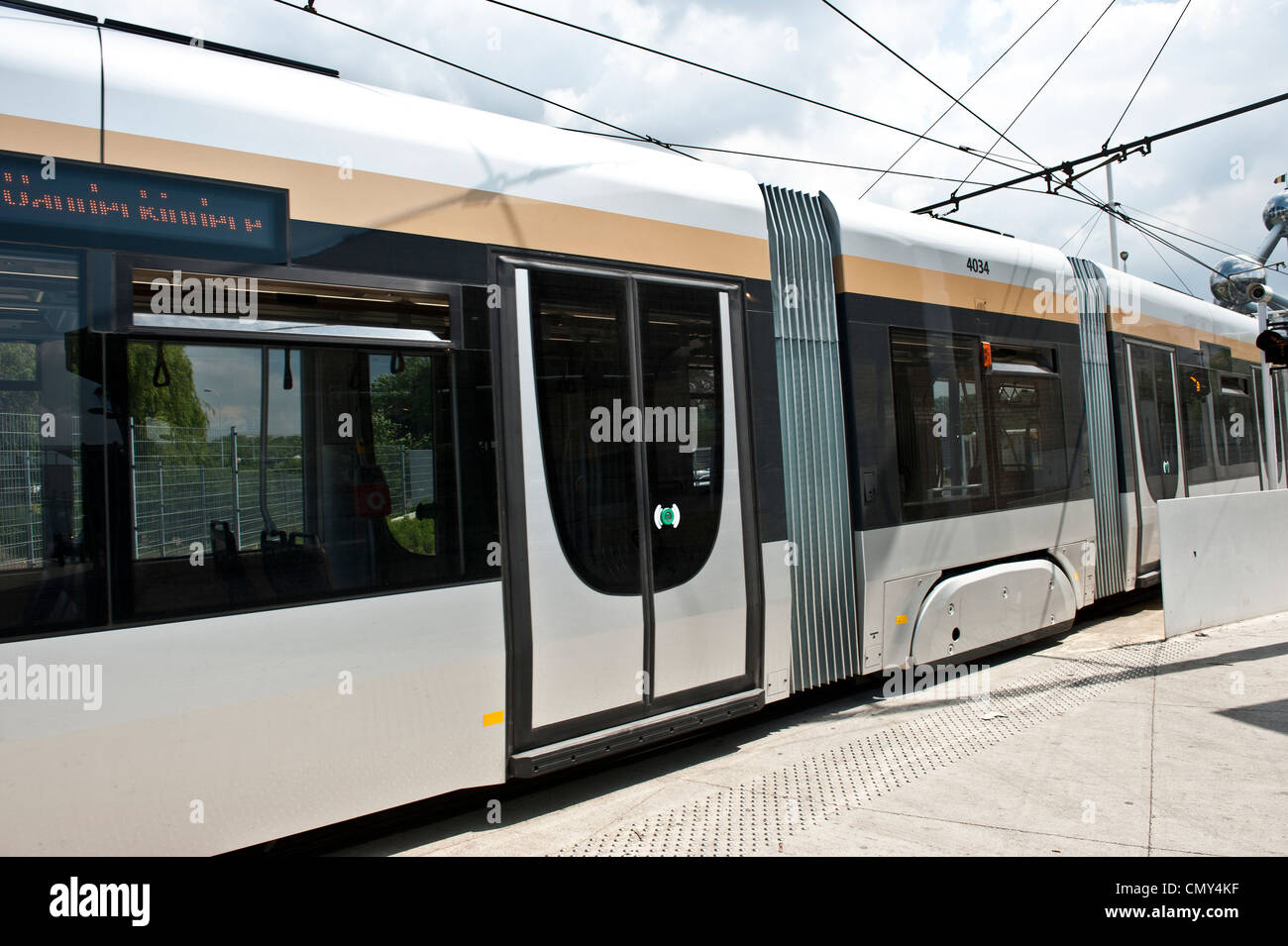 A Golden and white electric bus near The Atomium in Brussels Stock ...