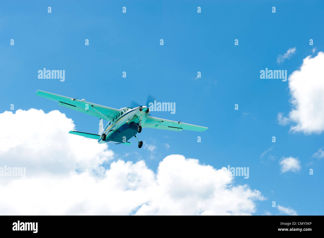 A small private plane approaching an island Stock Photo - Alamy
