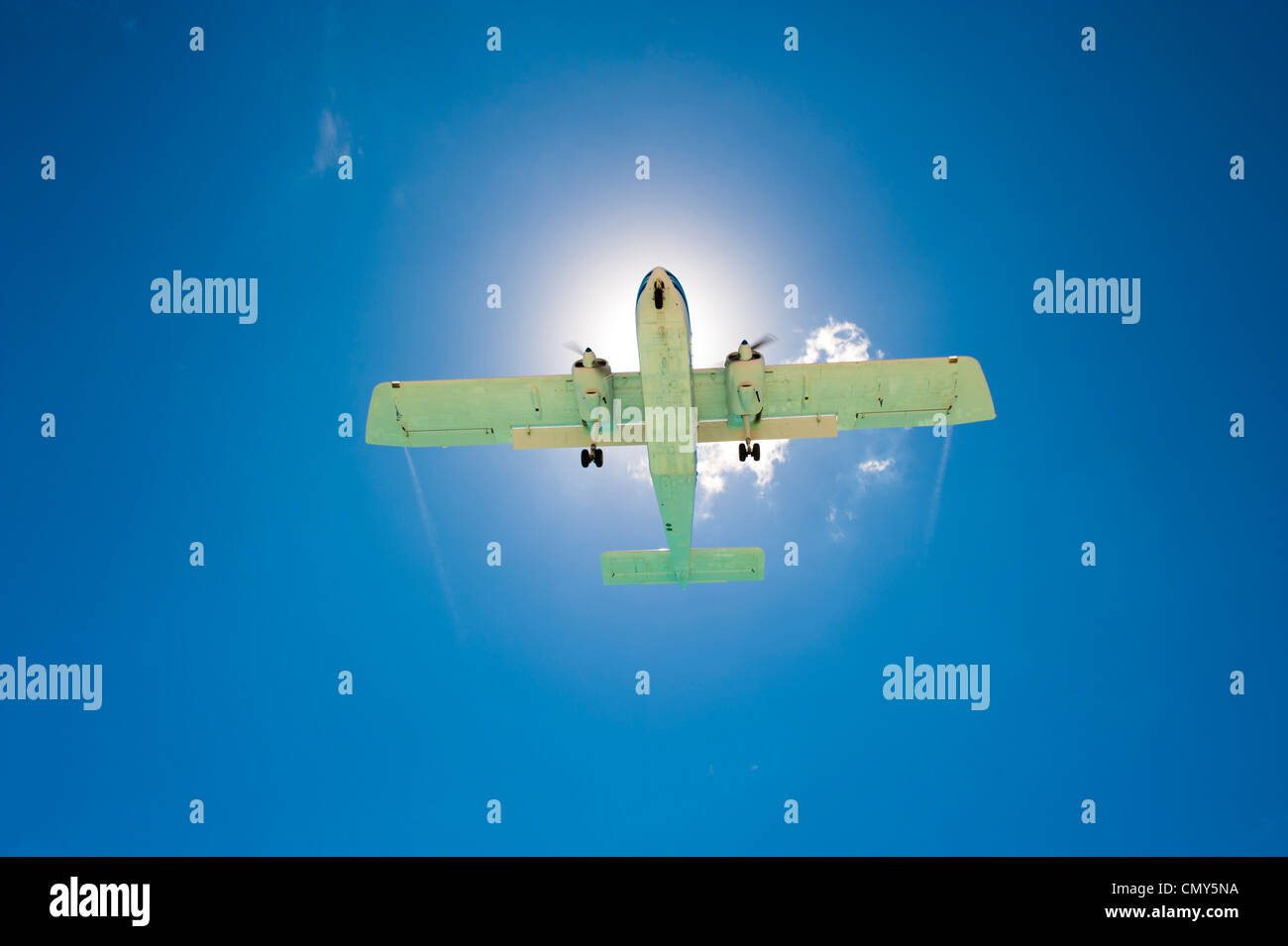 A nice color shot of the sunshine beaming directly above an airplane ...