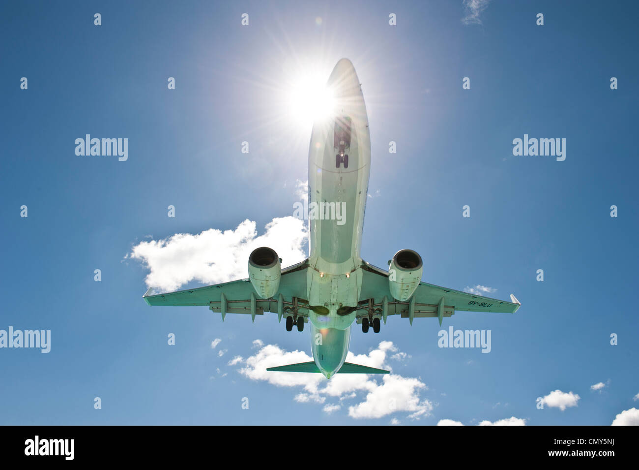 A nice color shot of the sunshine beaming directly above an airplane ...