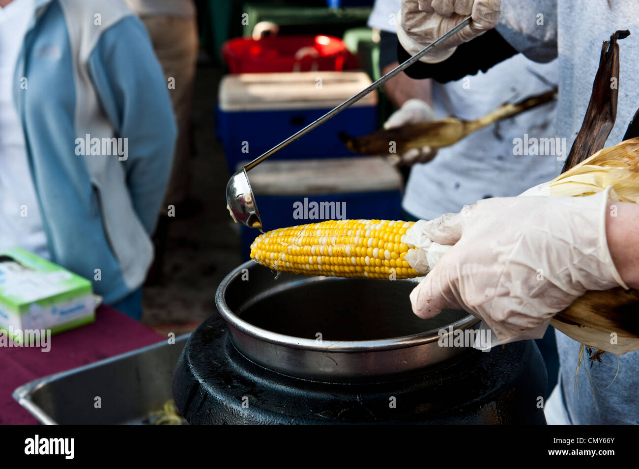 Chef preparing delicious corn on the cob with butter Stock Photo - Alamy