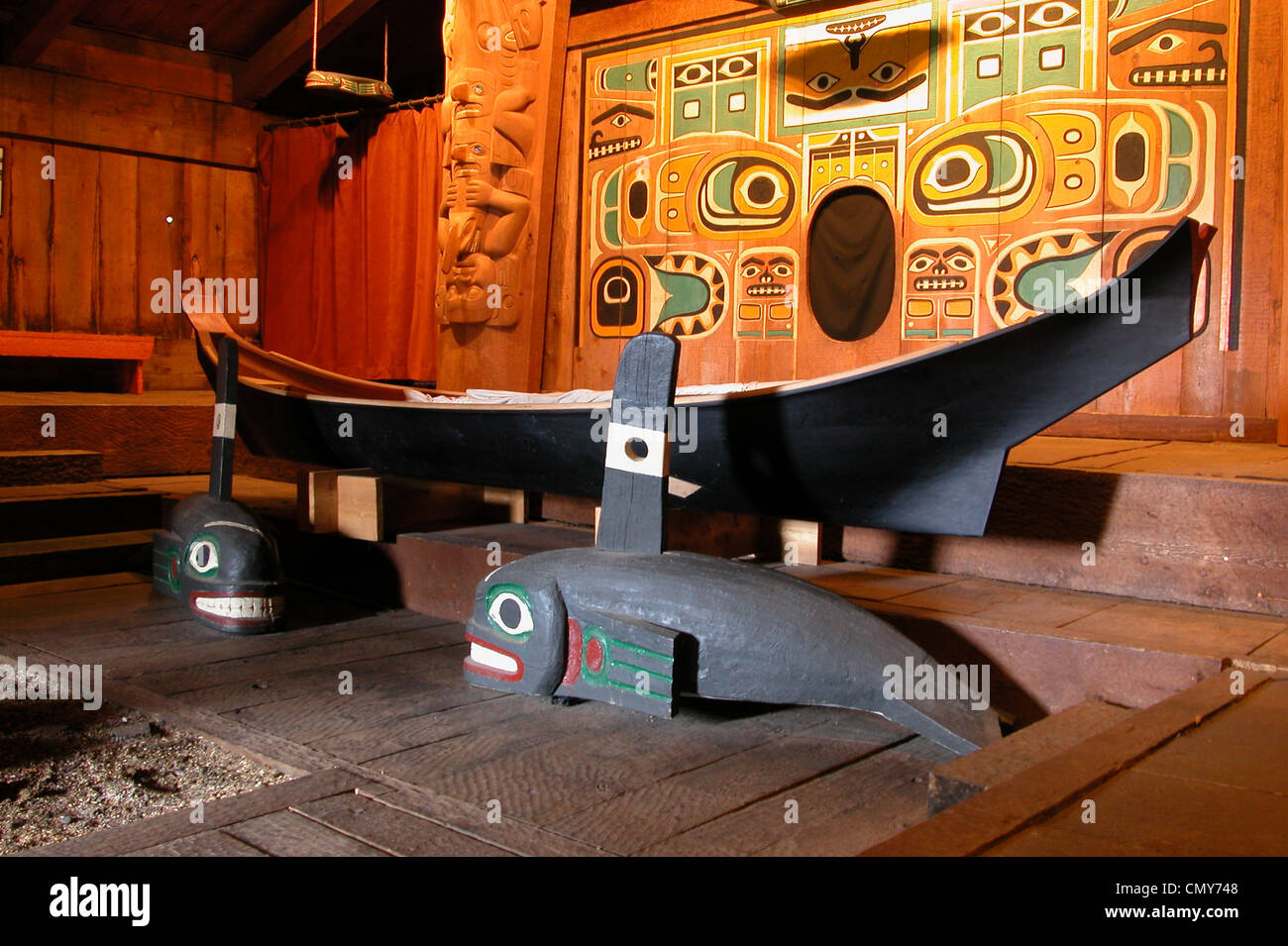 Tlingit native Longhouse with a canoe and Killer Whale carvings ...