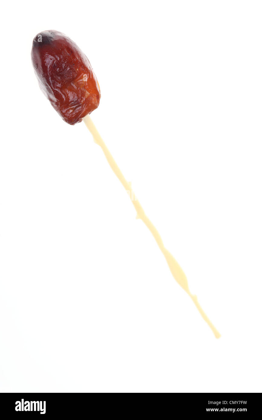 Dried date fruits in hand isolated on white background Stock Photo - Alamy