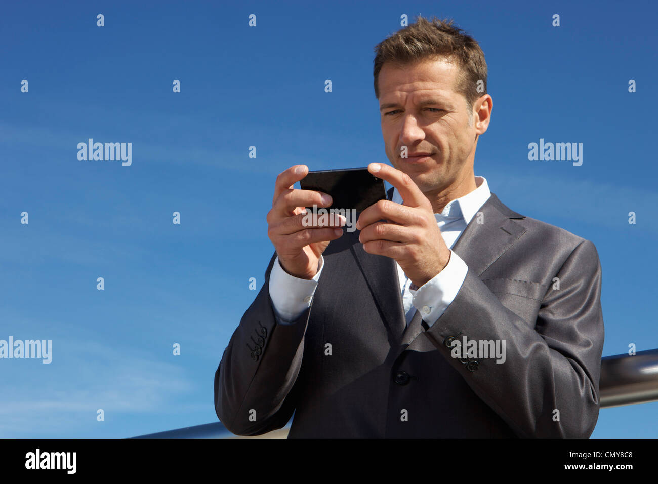 Germany, Bavaria, Munich, Businessman using cell phone Stock Photo - Alamy