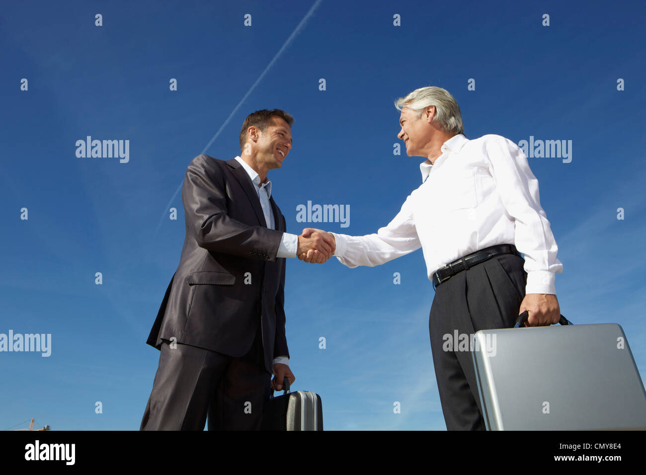 Germany, Bavaria, Munich, Business people shaking hands, smiling Stock ...