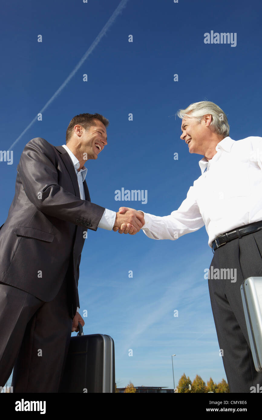 Germany, Bavaria, Munich, Business people shaking hands, smiling Stock ...