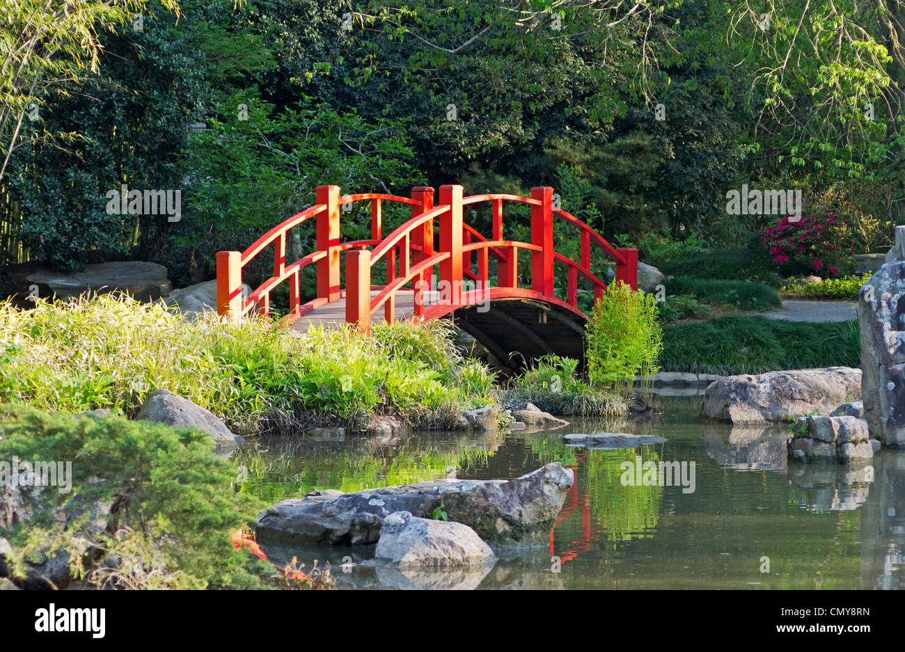 A red bridge in a Japanese garden Stock Photo - Alamy