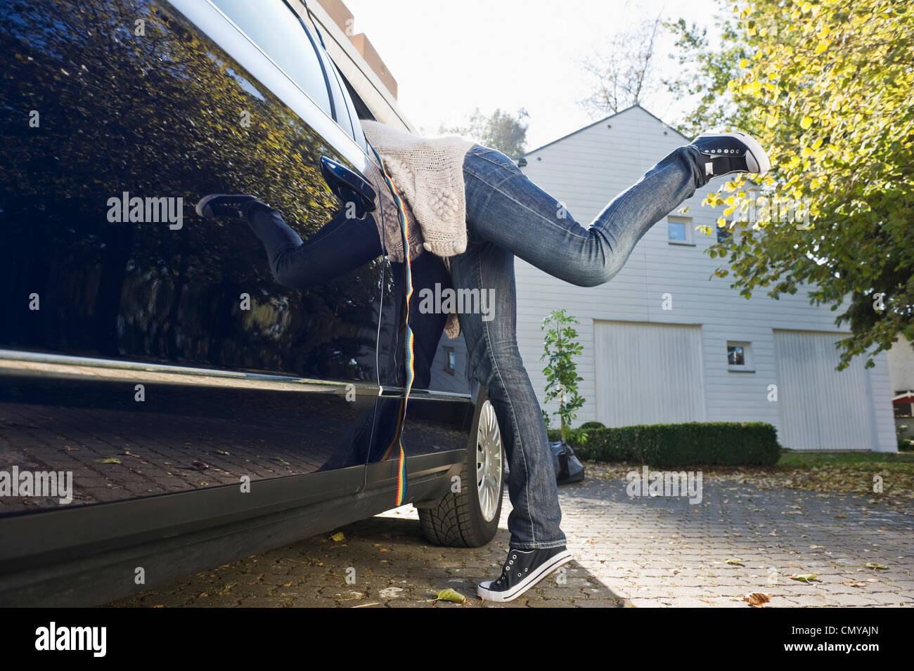 Germany, Bavaria, Grobenzell, Mid adult woman leaning car Stock Photo ...