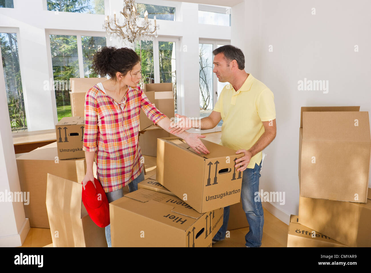 Germany Bavaria Grobenzell Couple Packing Cardboard Boxes For Moving