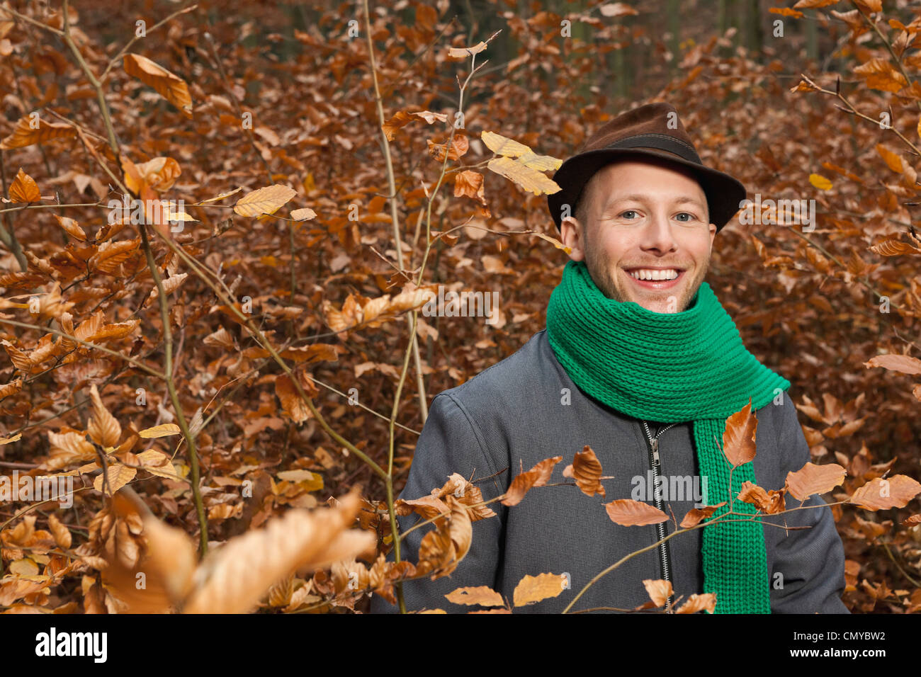 Germany, Berlin, Wandlitz, Young man smiling, portrait Stock Photo - Alamy