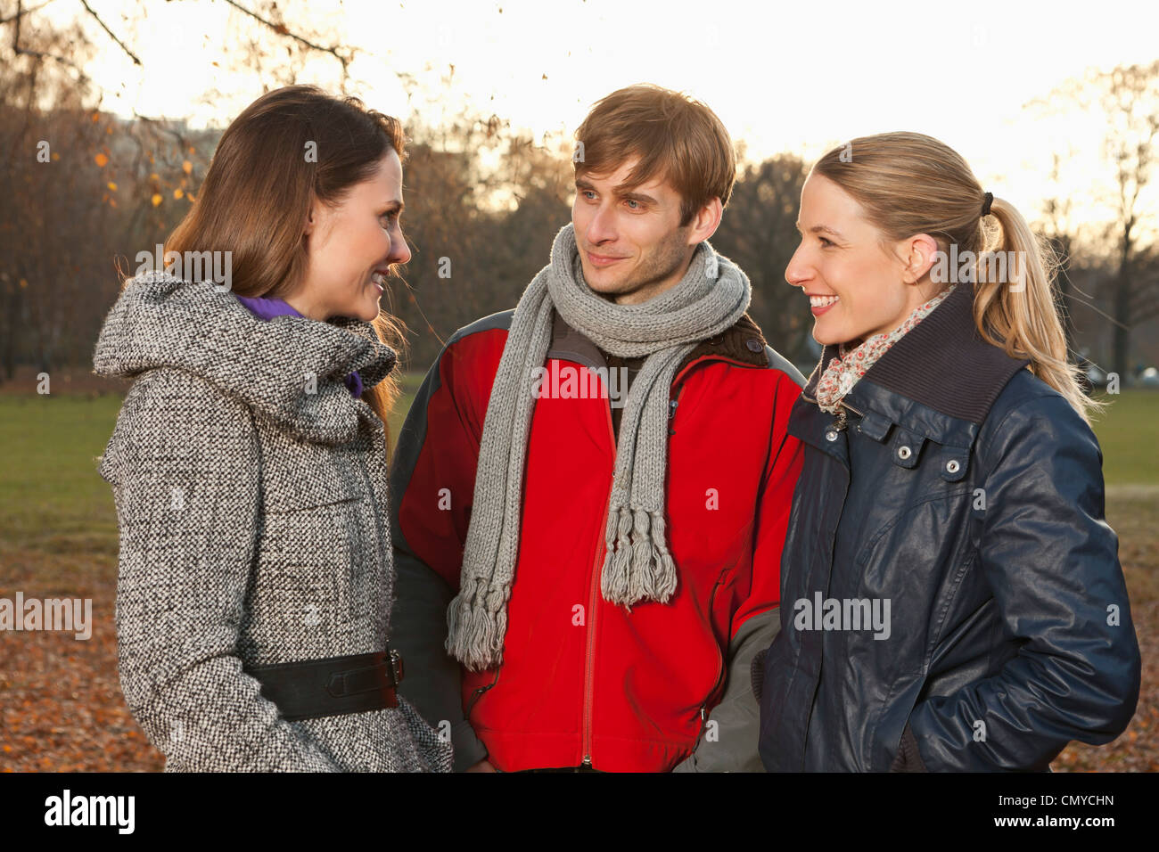 Germany, Berlin, Wandlitz, Friends talking together, smiling Stock ...