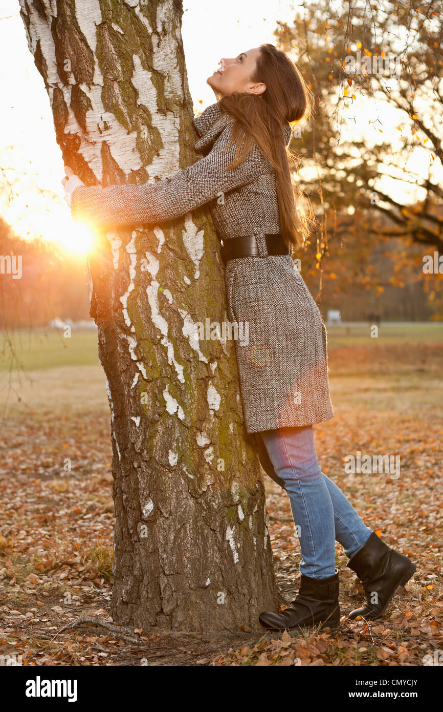 Germany, Berlin, Wandlitz, Mid adult woman hugging tree Stock Photo - Alamy