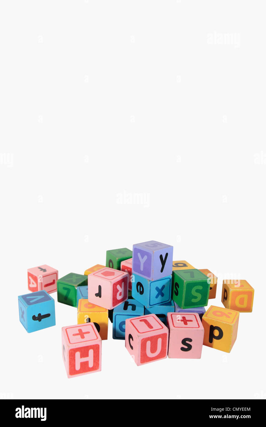 assorted childrens toy letter building blocks against a white ...
