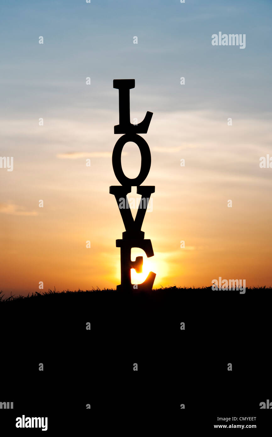 LOVE letters silhouette at sunset Stock Photo - Alamy