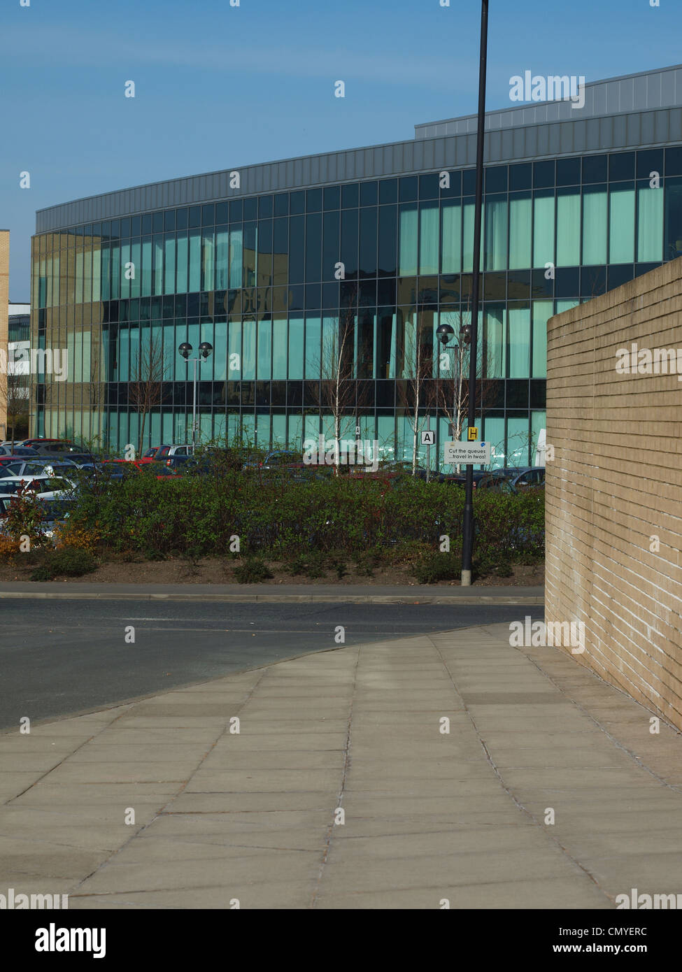A Pedestrian walkway flanked by a wall ,with class panel buildings in ...