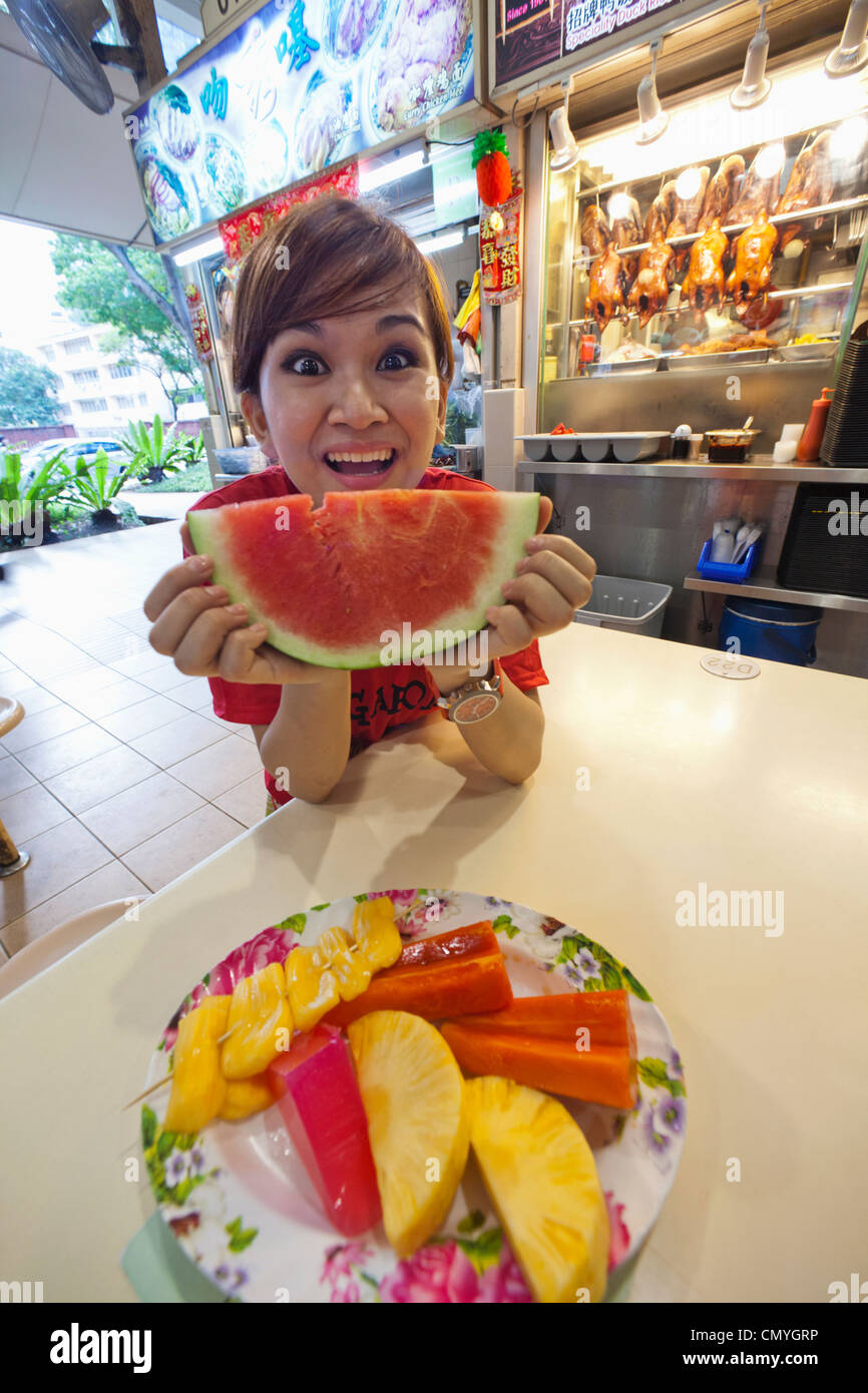 Singapore, Girl Eating Fruit in Typical Hawker Center Food Court Stock ...