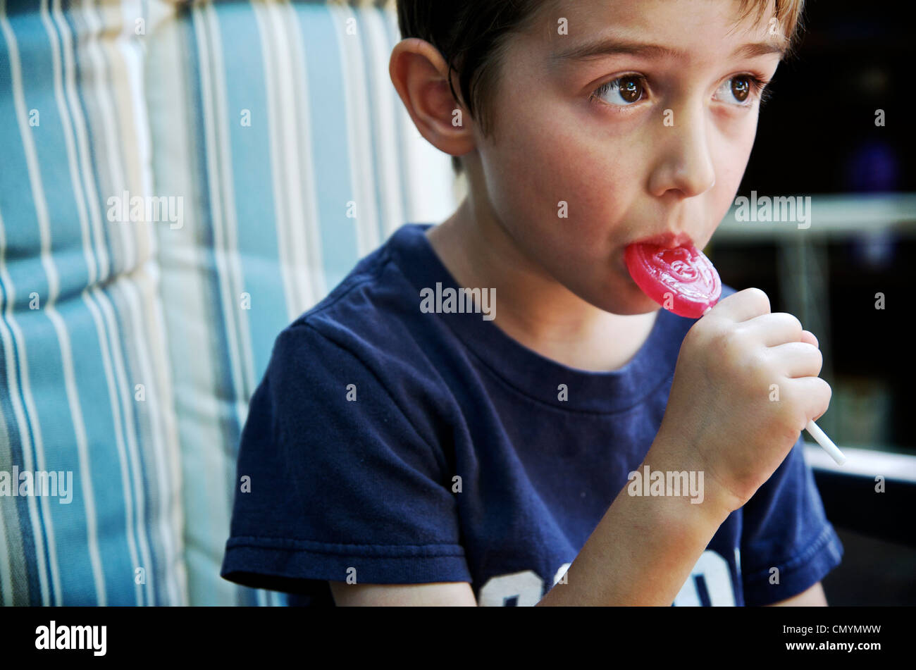 Boy eating a red lollipop, Otterburn, Quebec Stock Photo - Alamy