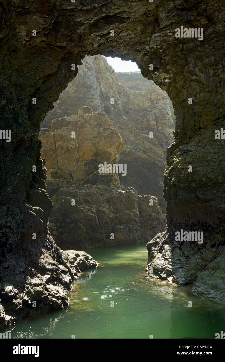 Large natural rock arch and pool on Perranporth beach in Cornwall UK ...
