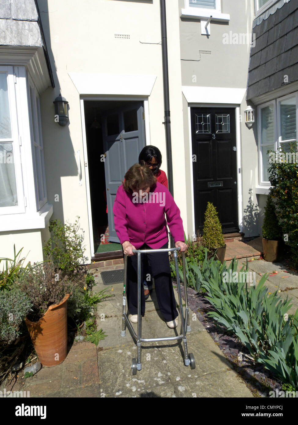 Old lady and zimmer frame hi-res stock photography and images - Alamy
