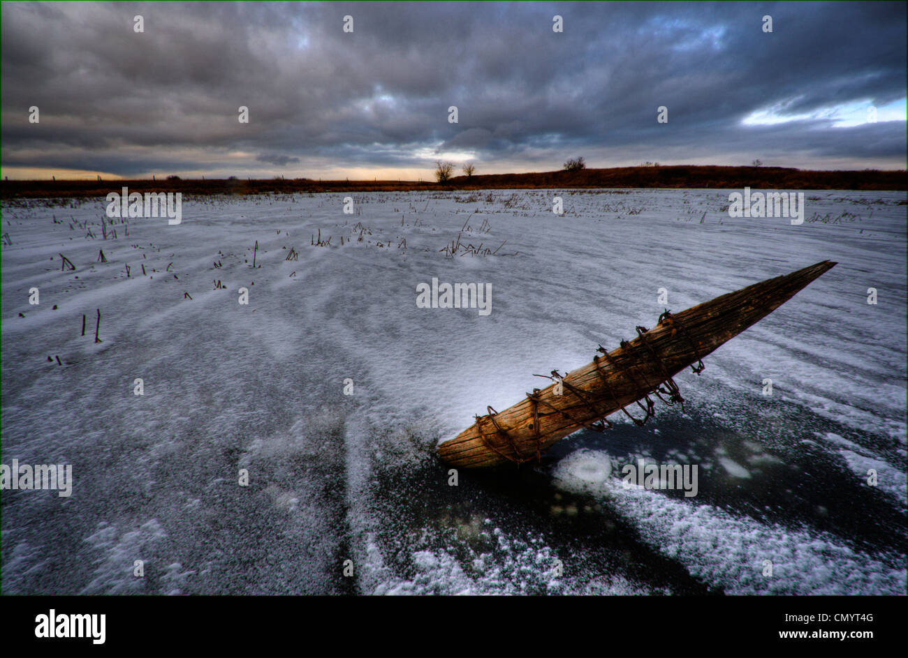 Frozen Prairie Pond With a Fence Post and Barbed Wire Poking Out ...