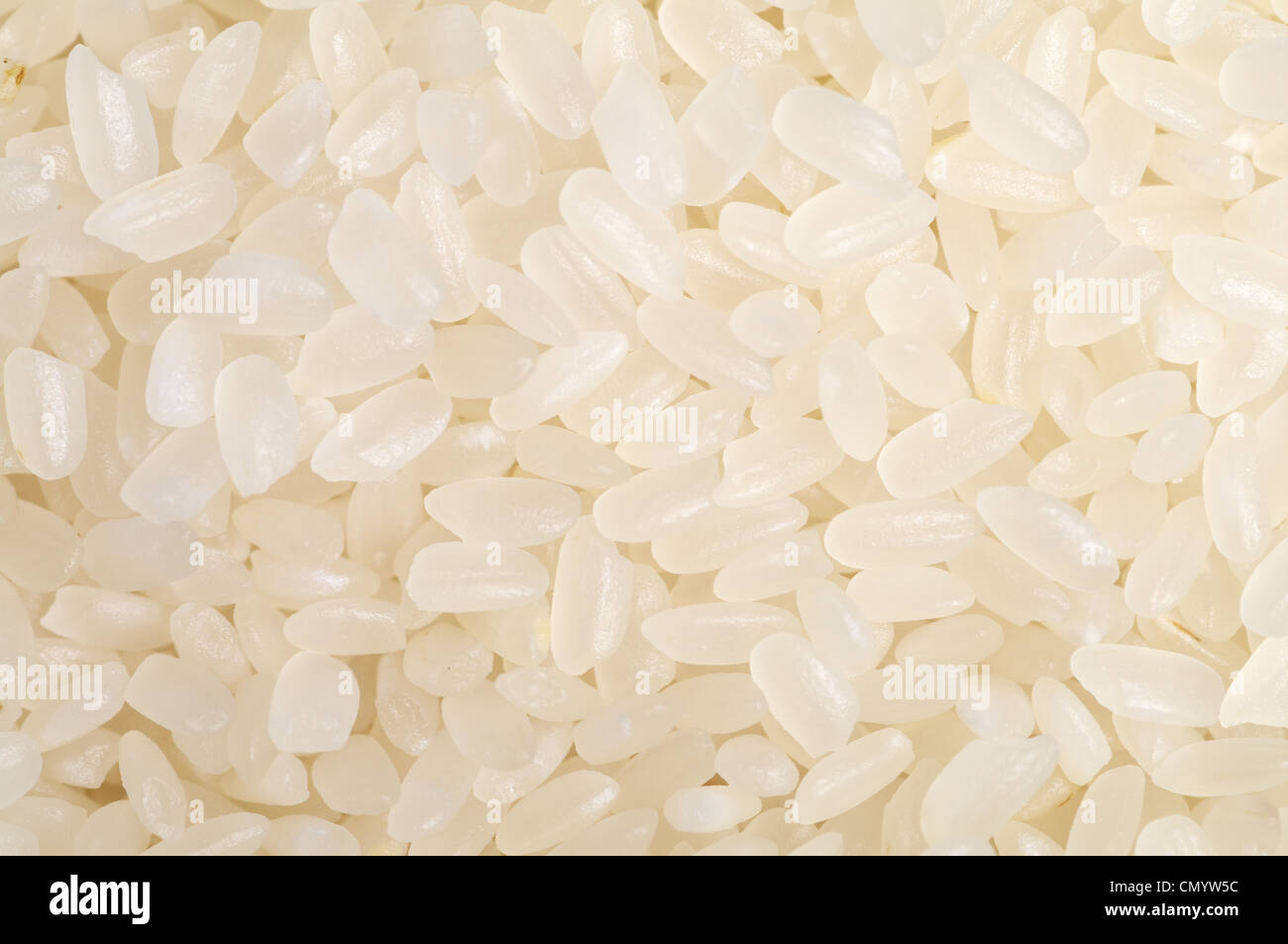 Uncooked white rice background Stock Photo - Alamy