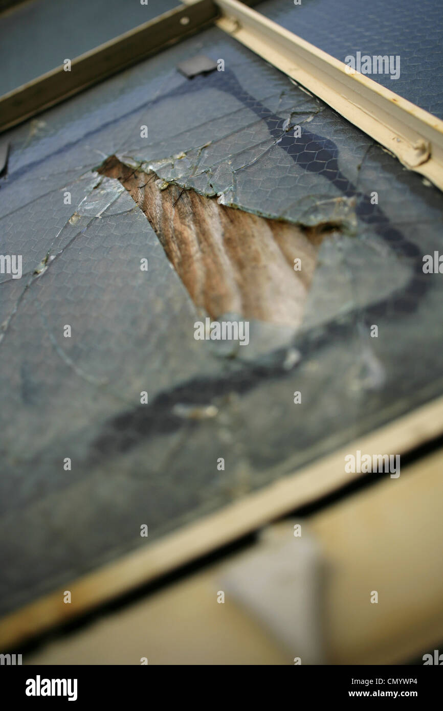 Broken wire reinforced window in disused industrial building Stock ...