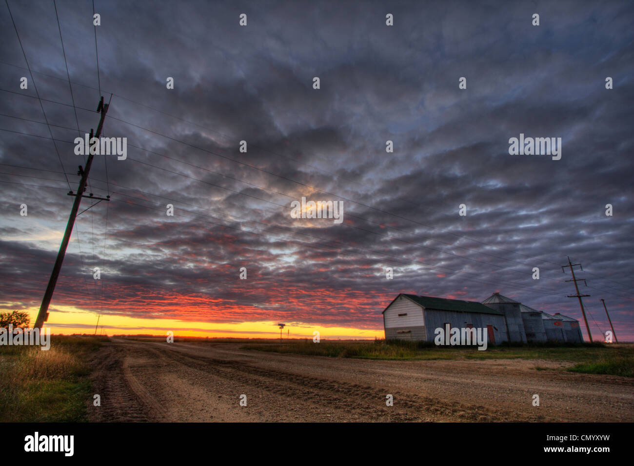 Grain silos and farm buildings during a fall sunset north of Legal ...