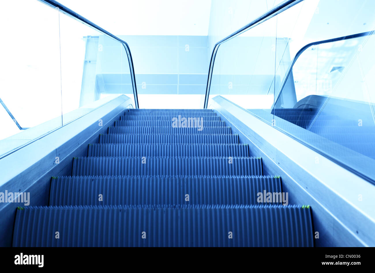 Perspective of escalator toned in blue color Stock Photo - Alamy