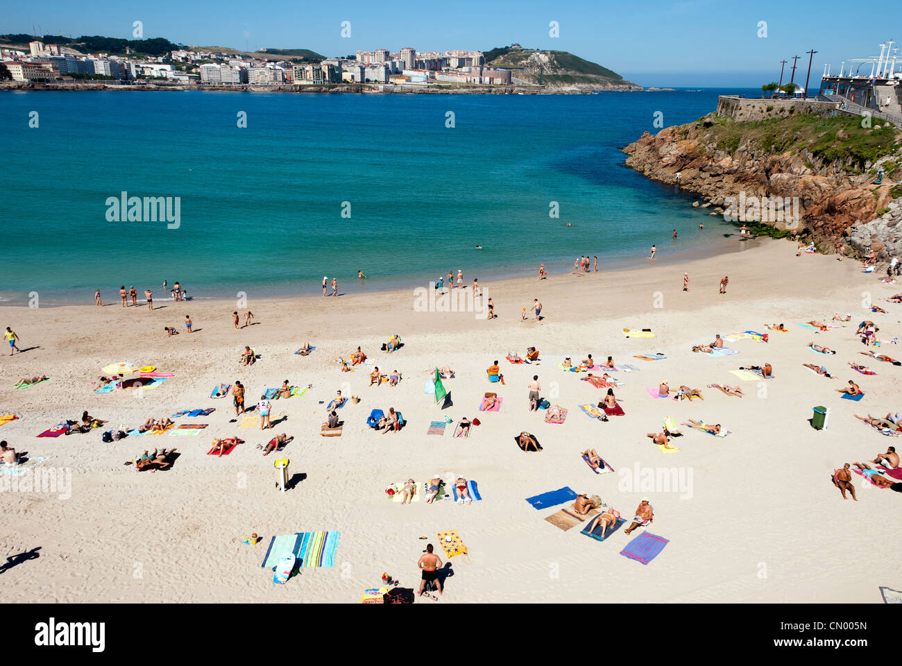 people sun bathing at playa de Orzan beach - Coruna, Galicia - Spain ...