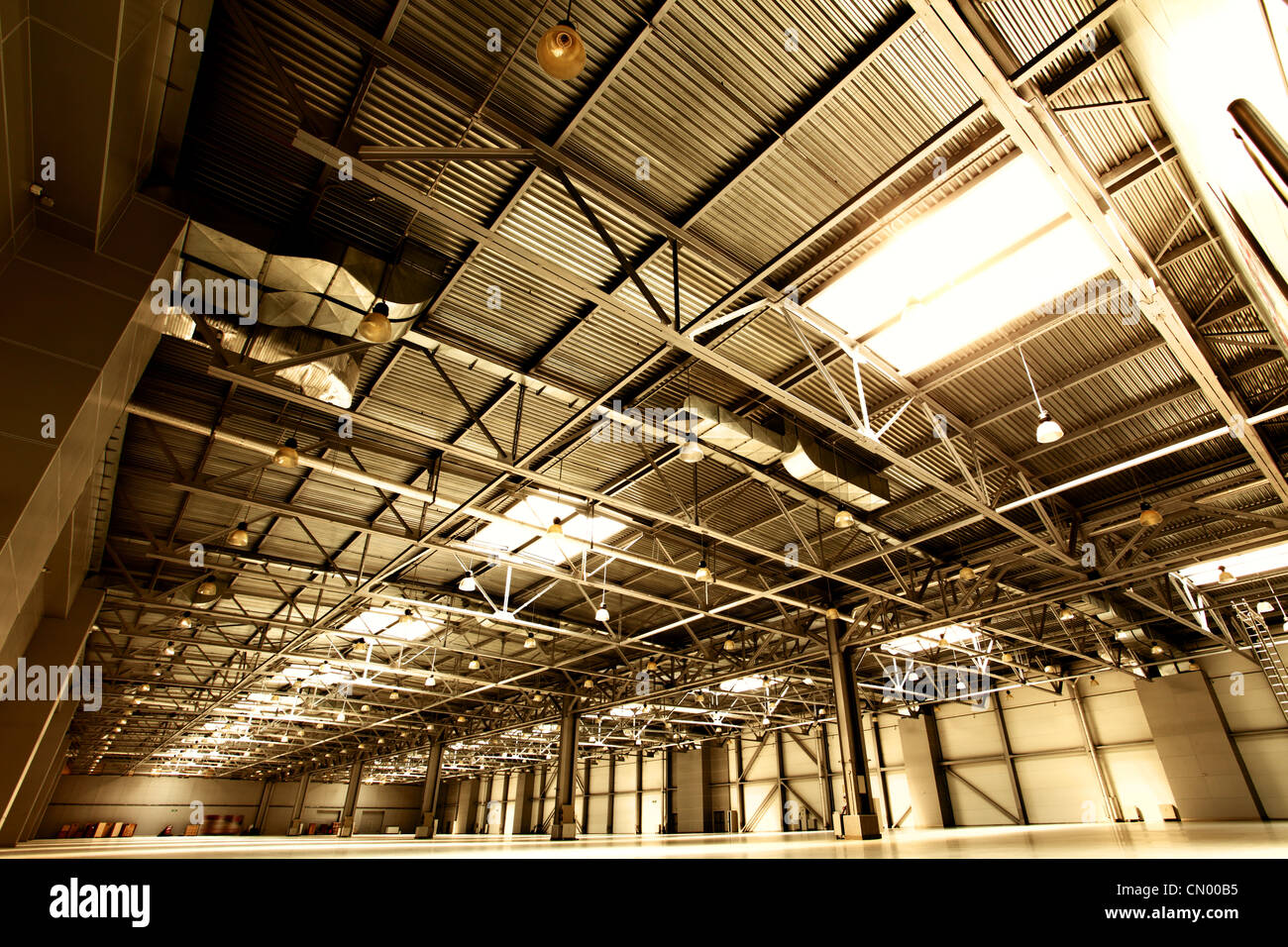 Wide angle shot of empty warehouse sepia toned Stock Photo - Alamy
