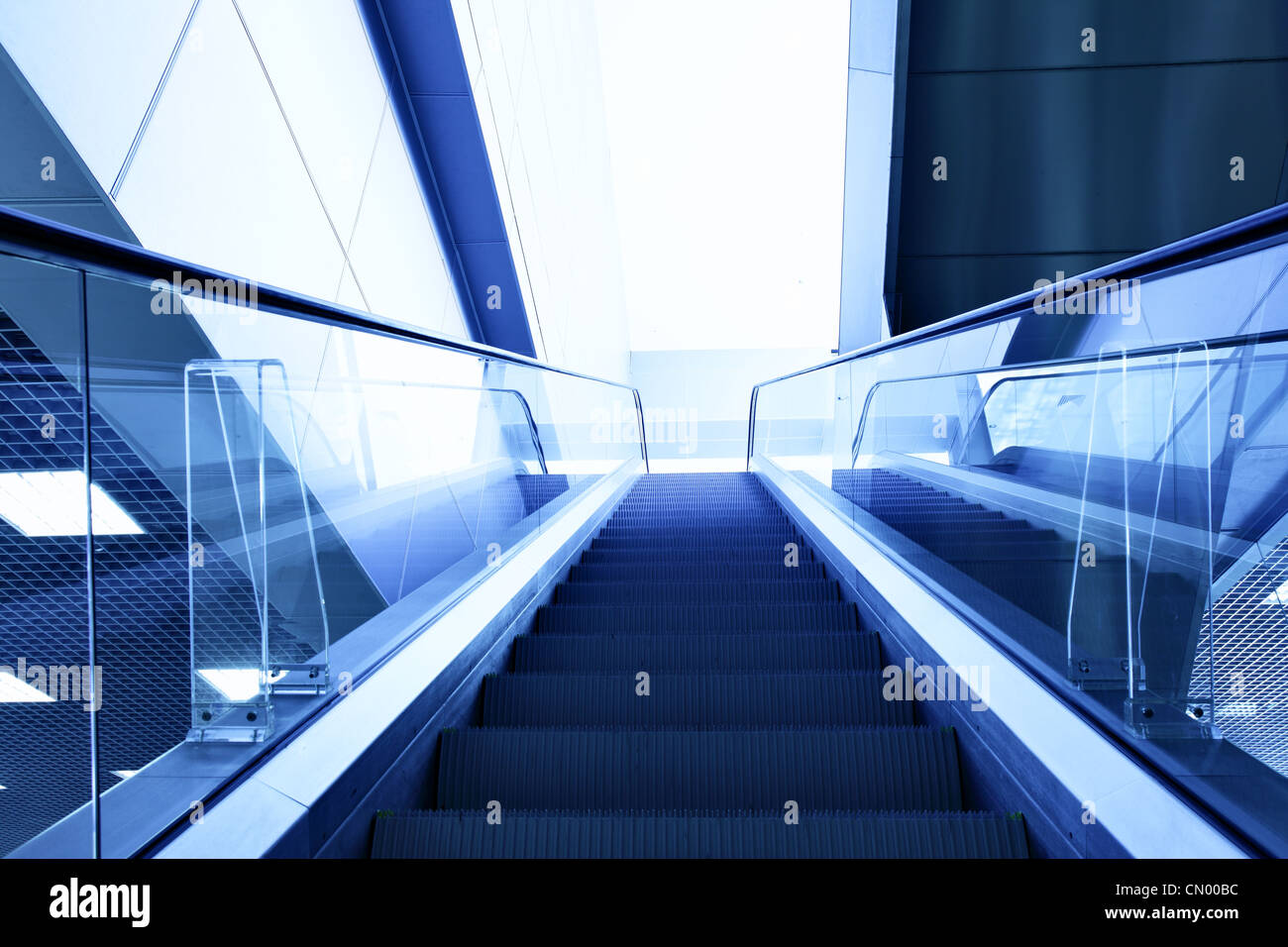 Perspective of escalator toned in blue color Stock Photo - Alamy