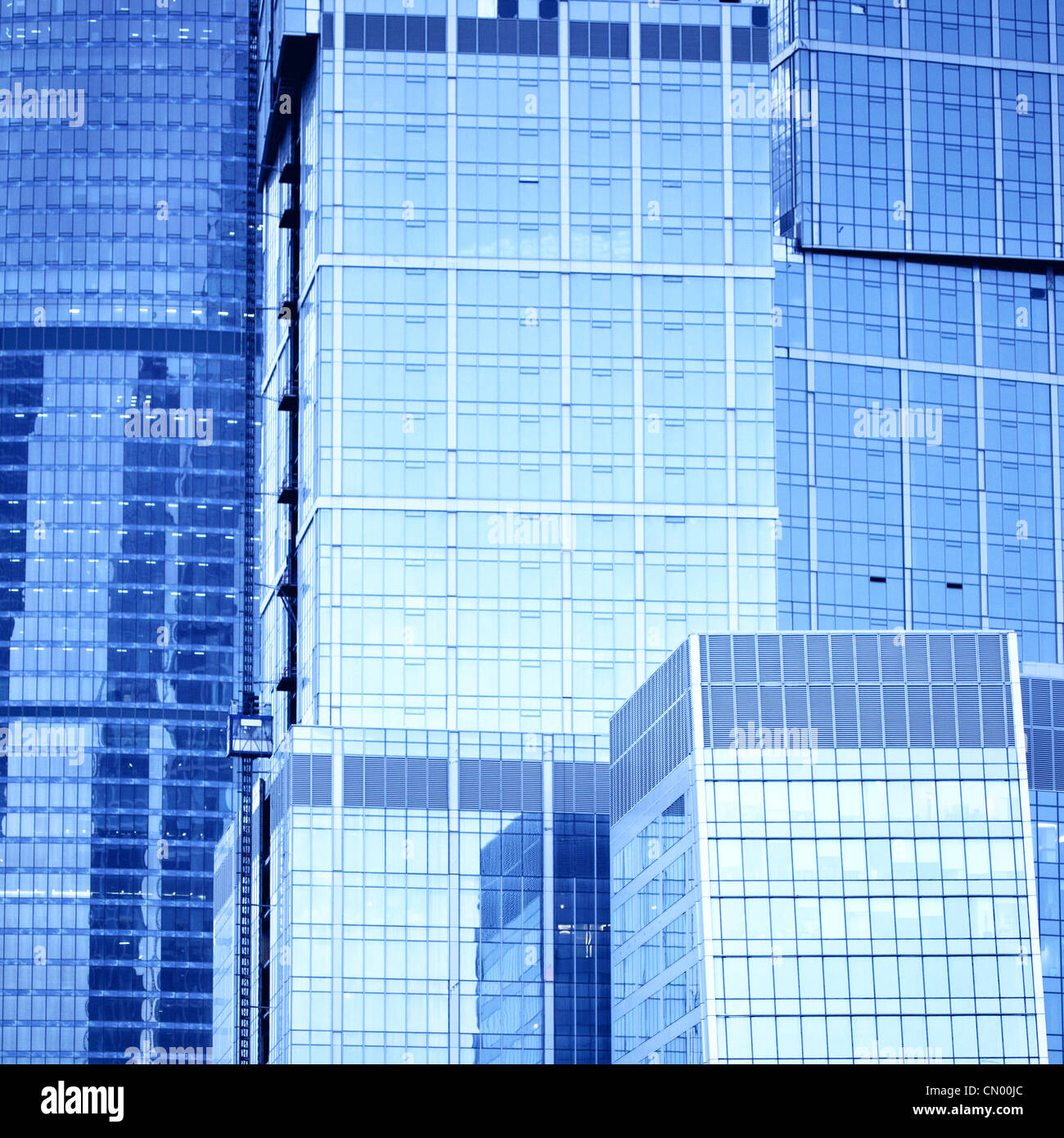 Modern skyscrapers close-up toned in blue color Stock Photo - Alamy