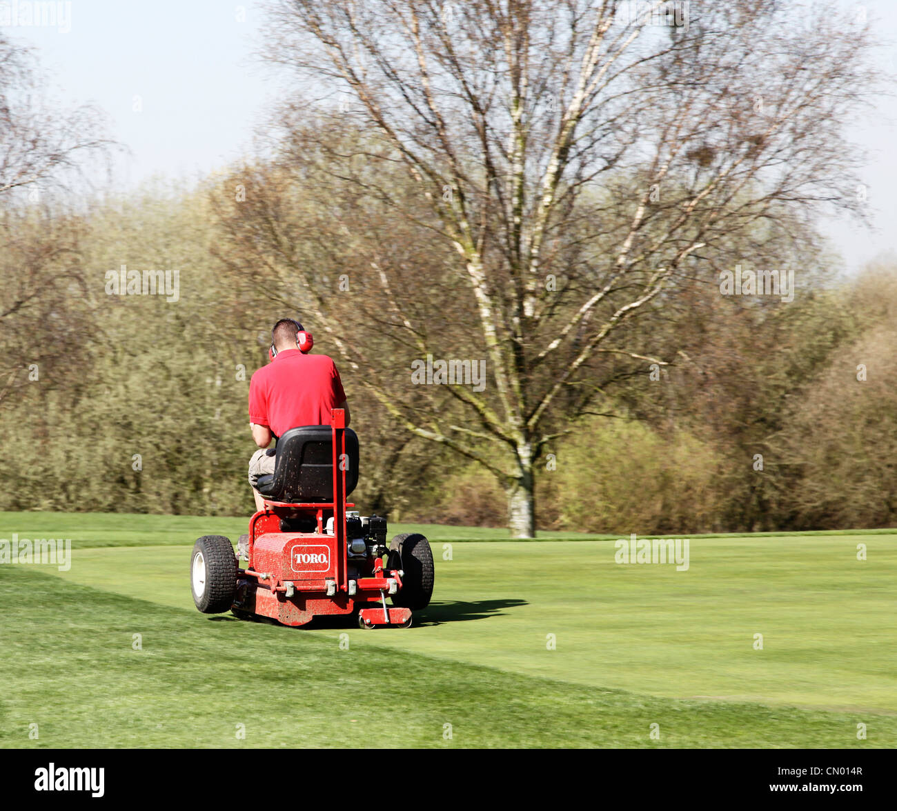A greenkeeper mowing a lush green golf course ahead of the predicted ...