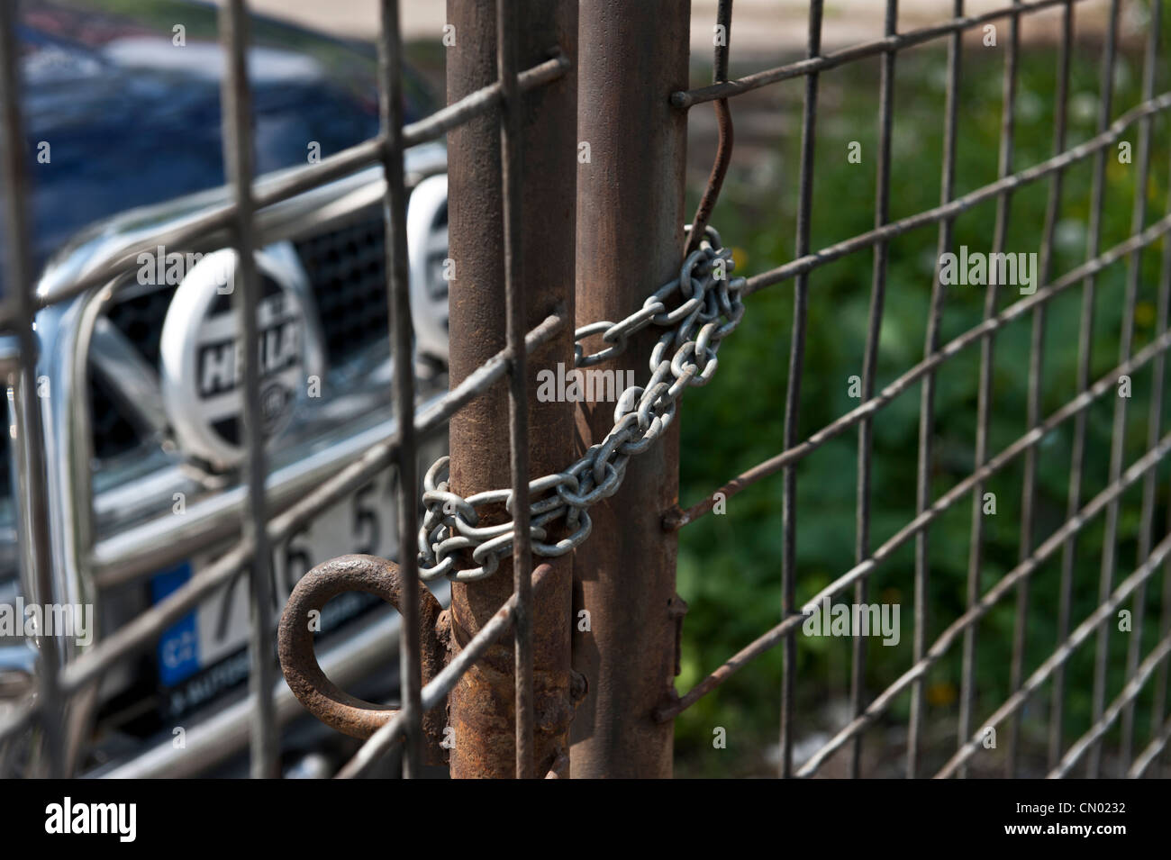 A tight, chained lock on a parking lot fence Stock Photo - Alamy
