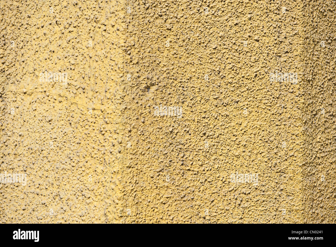 A yellow, sandy pattern of a stucco building Stock Photo - Alamy