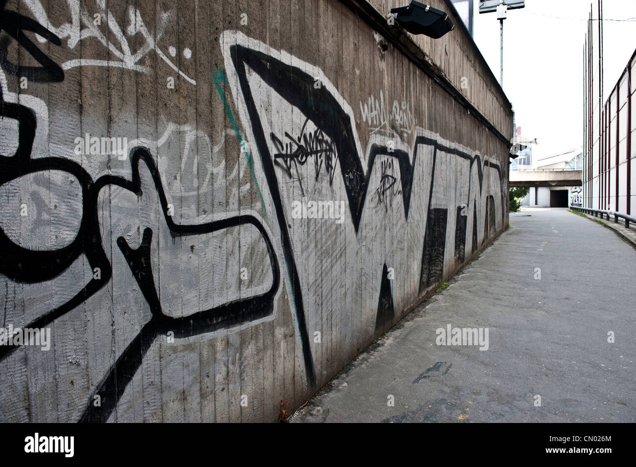 A gangway of an urban neighborhood with graffiti scattered down the ...