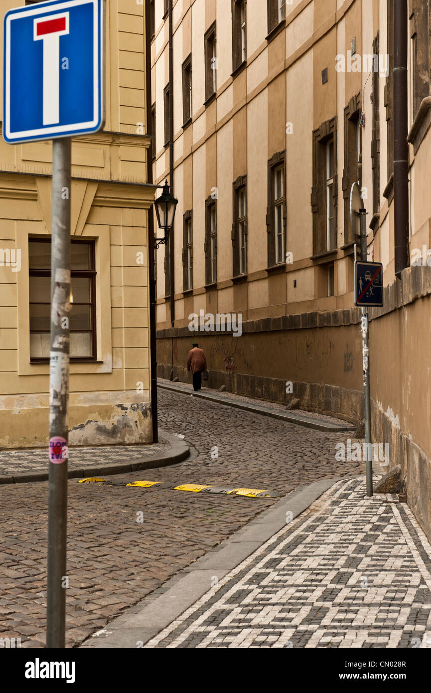 A man walking down a winding street in the Czech Republic Stock Photo ...