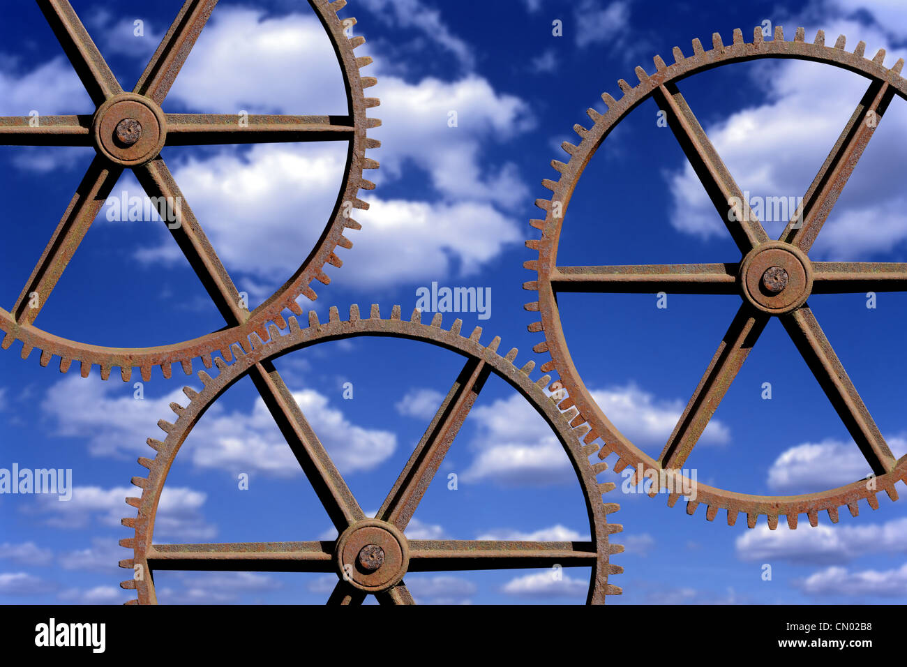 Rusty cogs against a sky background Stock Photo - Alamy