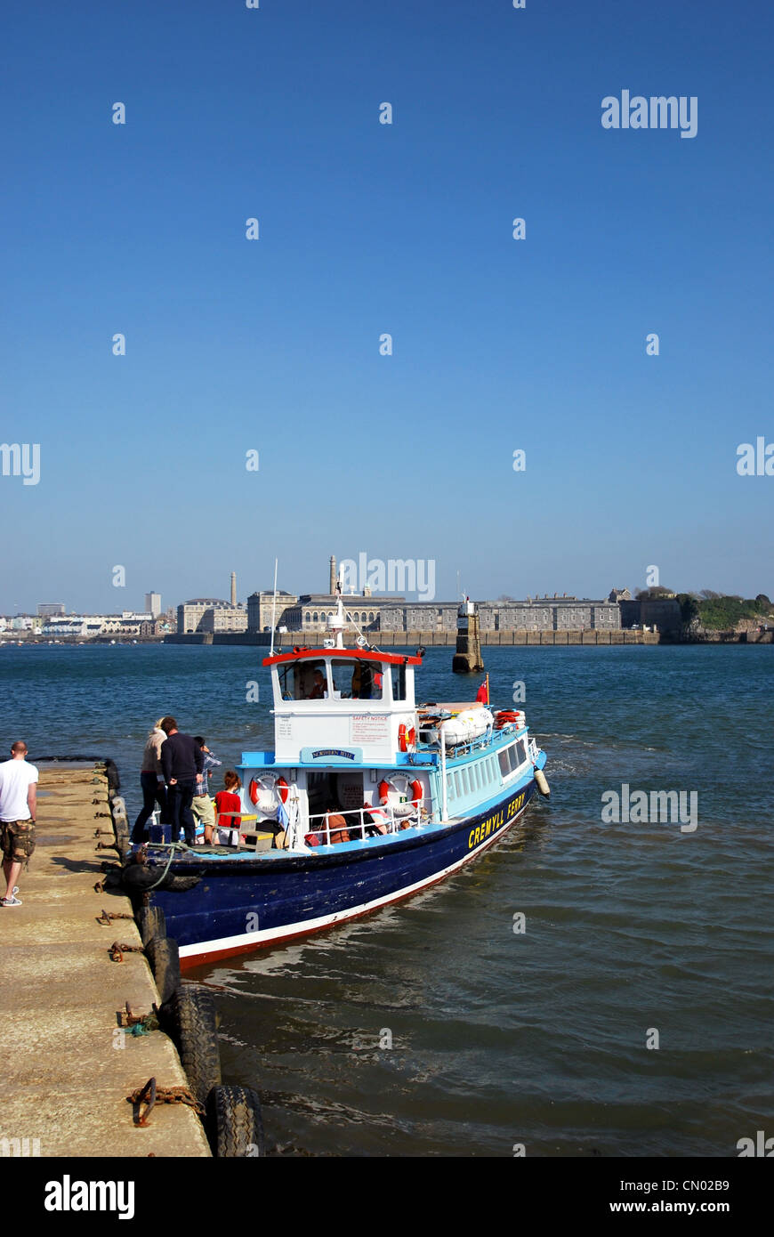 The Cremyll Ferry loads with passengers on a sunny day and in blue sky ...