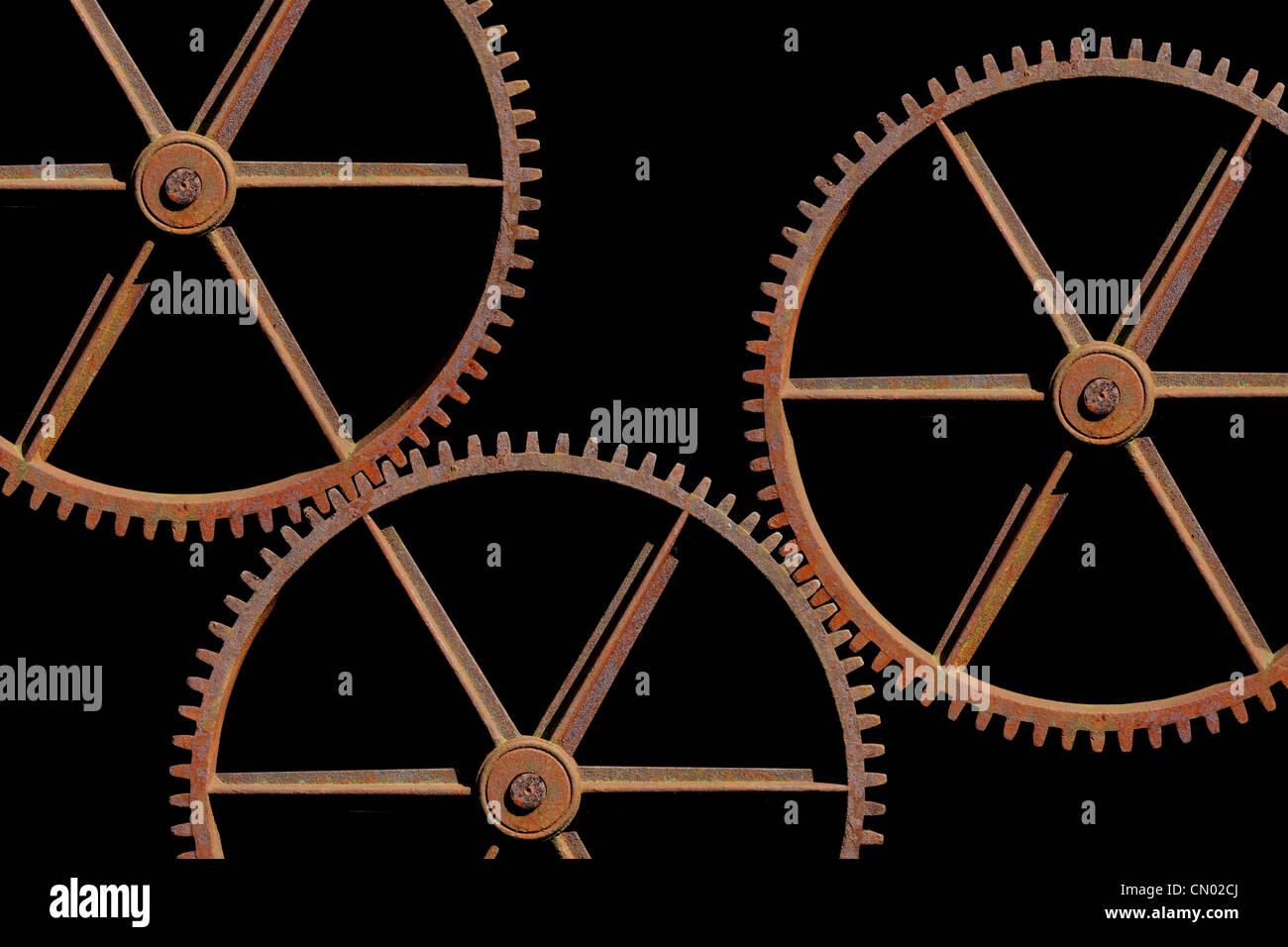 Rusty cogs against a black background Stock Photo - Alamy
