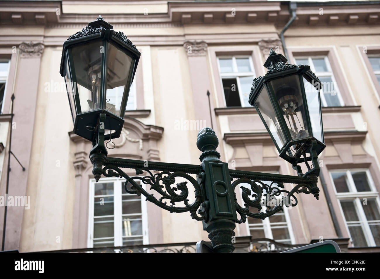 A left low angle shot of a forest green lamp post in front of a massive ...