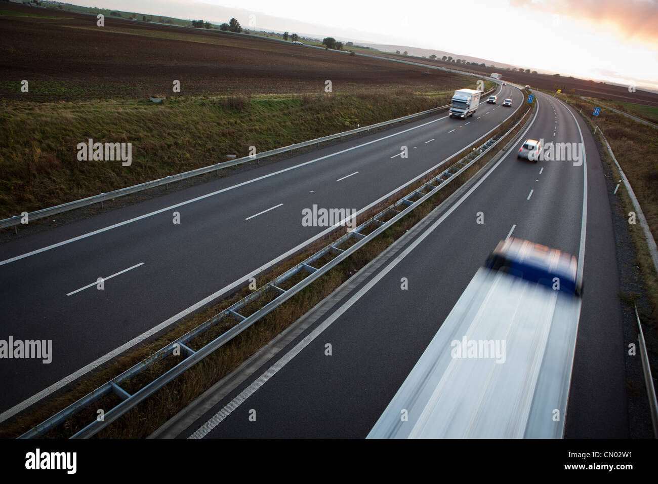 highway traffic - motion blurred truck on a highway/motorway/speedway ...