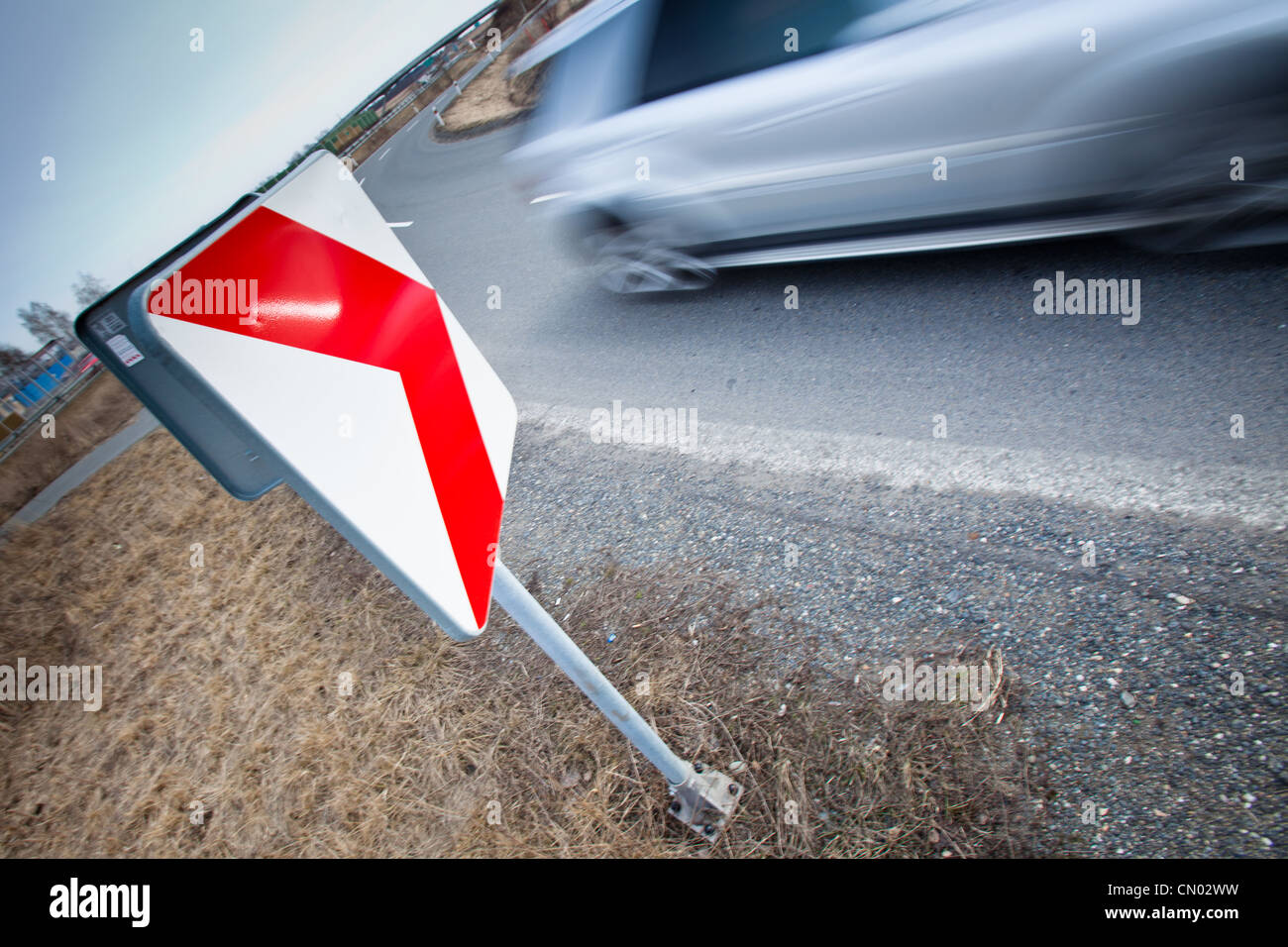 Traffic concept: car driving fast through a sharp turn (motion blur is ...