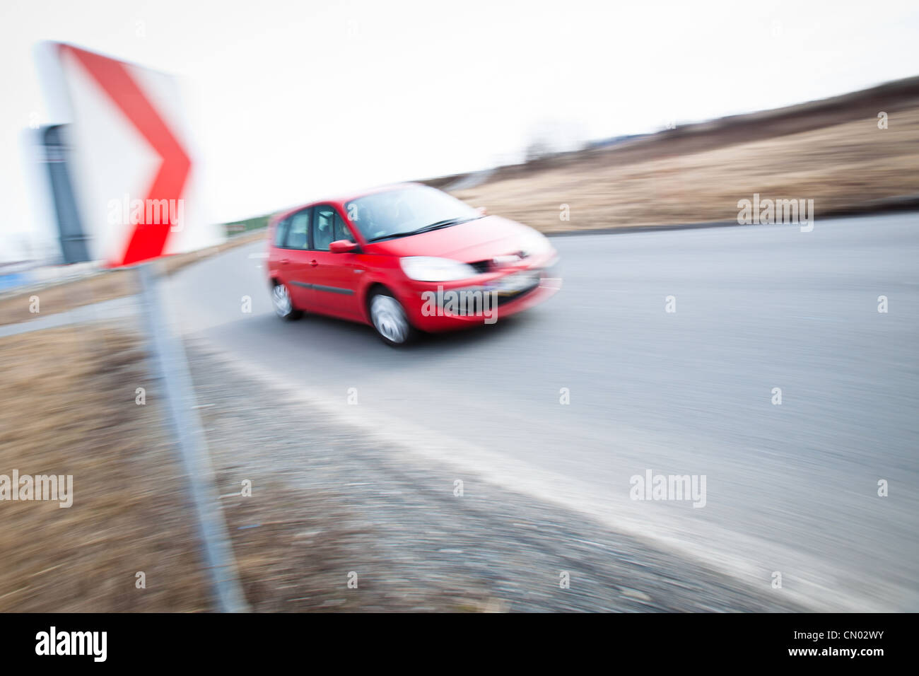 Traffic concept: car driving fast through a sharp turn (motion blur is ...